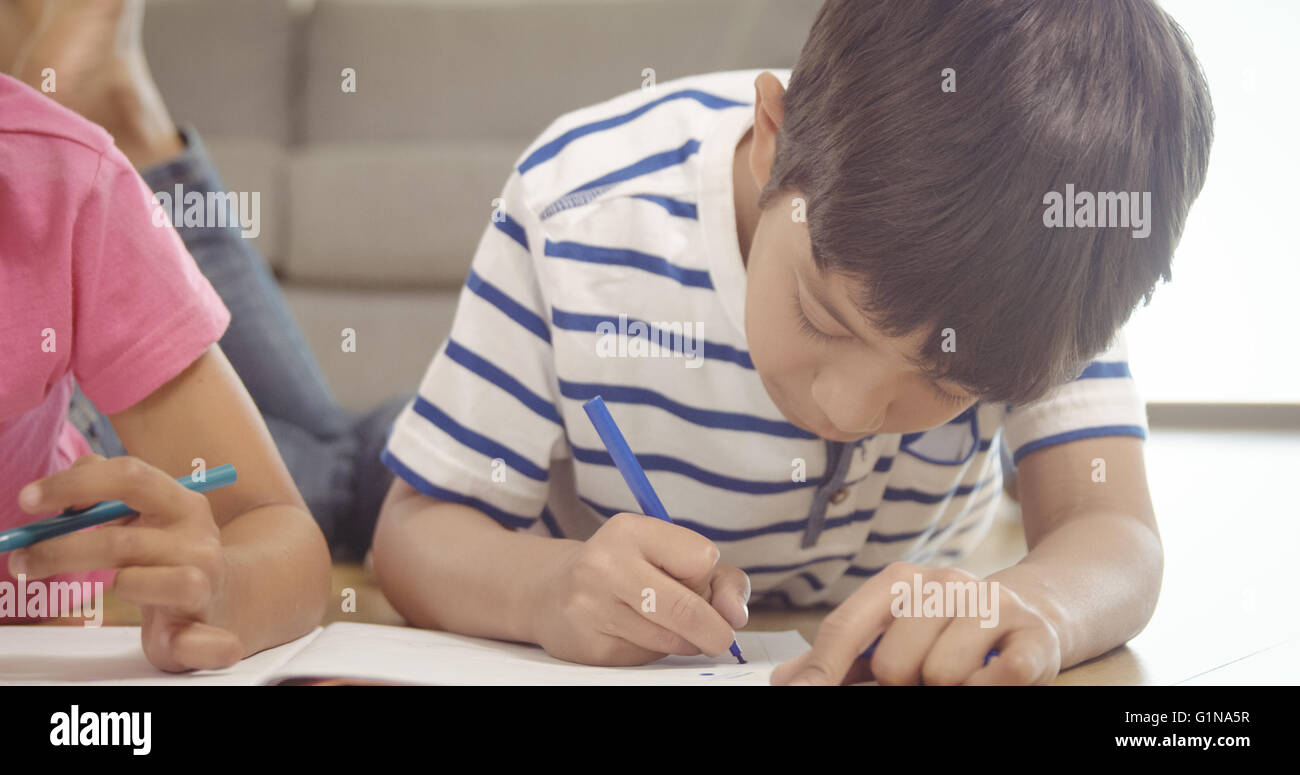 Cute siblings drawing on a notebook Stock Photo - Alamy