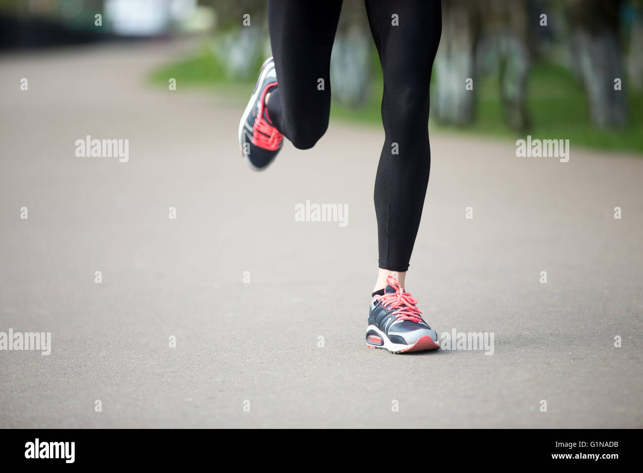 Legs of young female model running in park during everyday practice ...