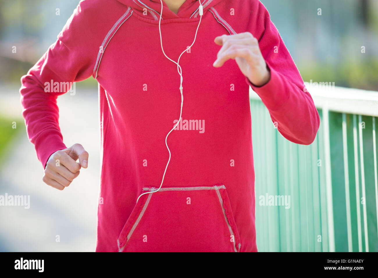 Torso of young female model running on the bridge during everyday ...