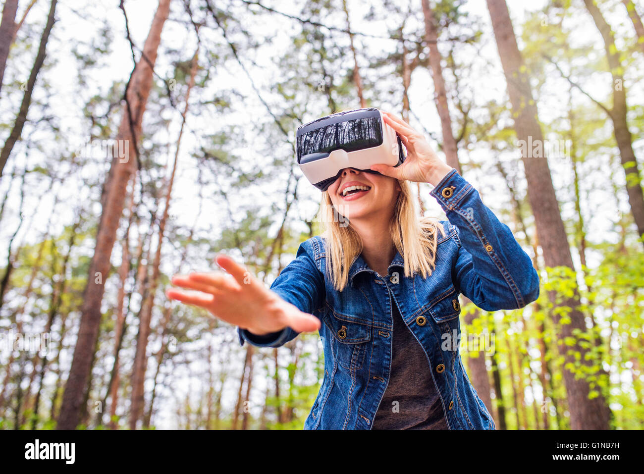 Woman wearing virtual reality goggles outside in spring nature Stock ...