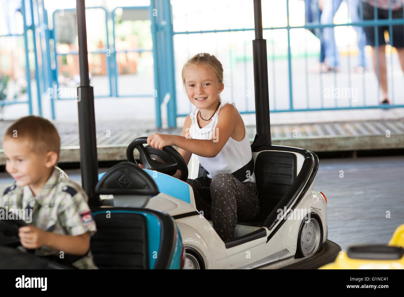 Happy child rides electric car at the park Stock Photo - Alamy