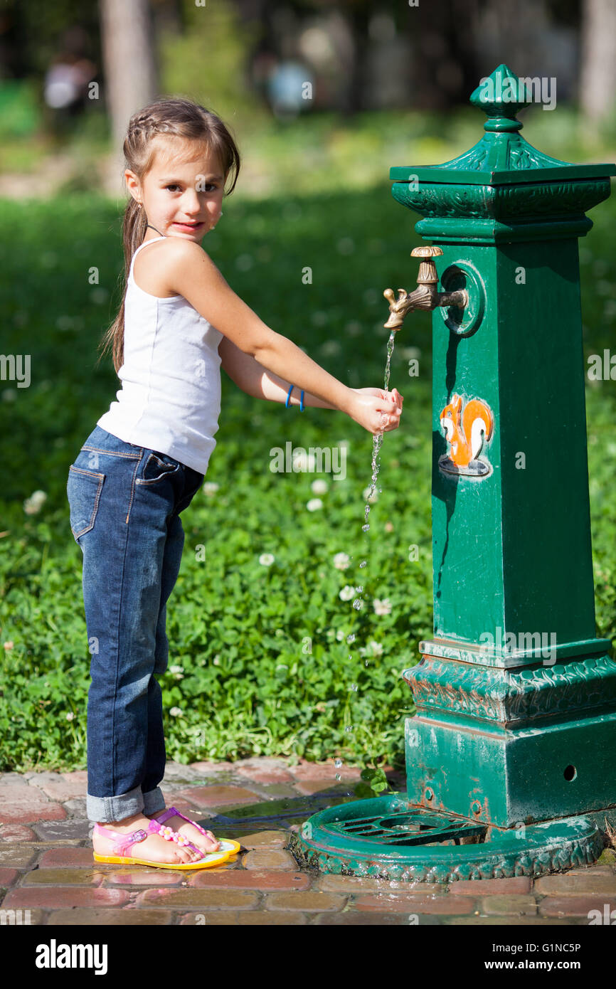 Girl splashing water at the park Stock Photo - Alamy