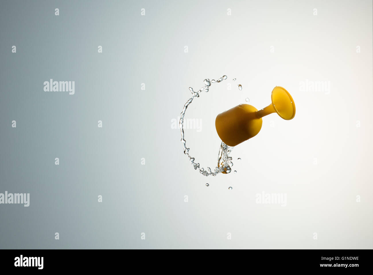 A goblet spilling out water Stock Photo - Alamy