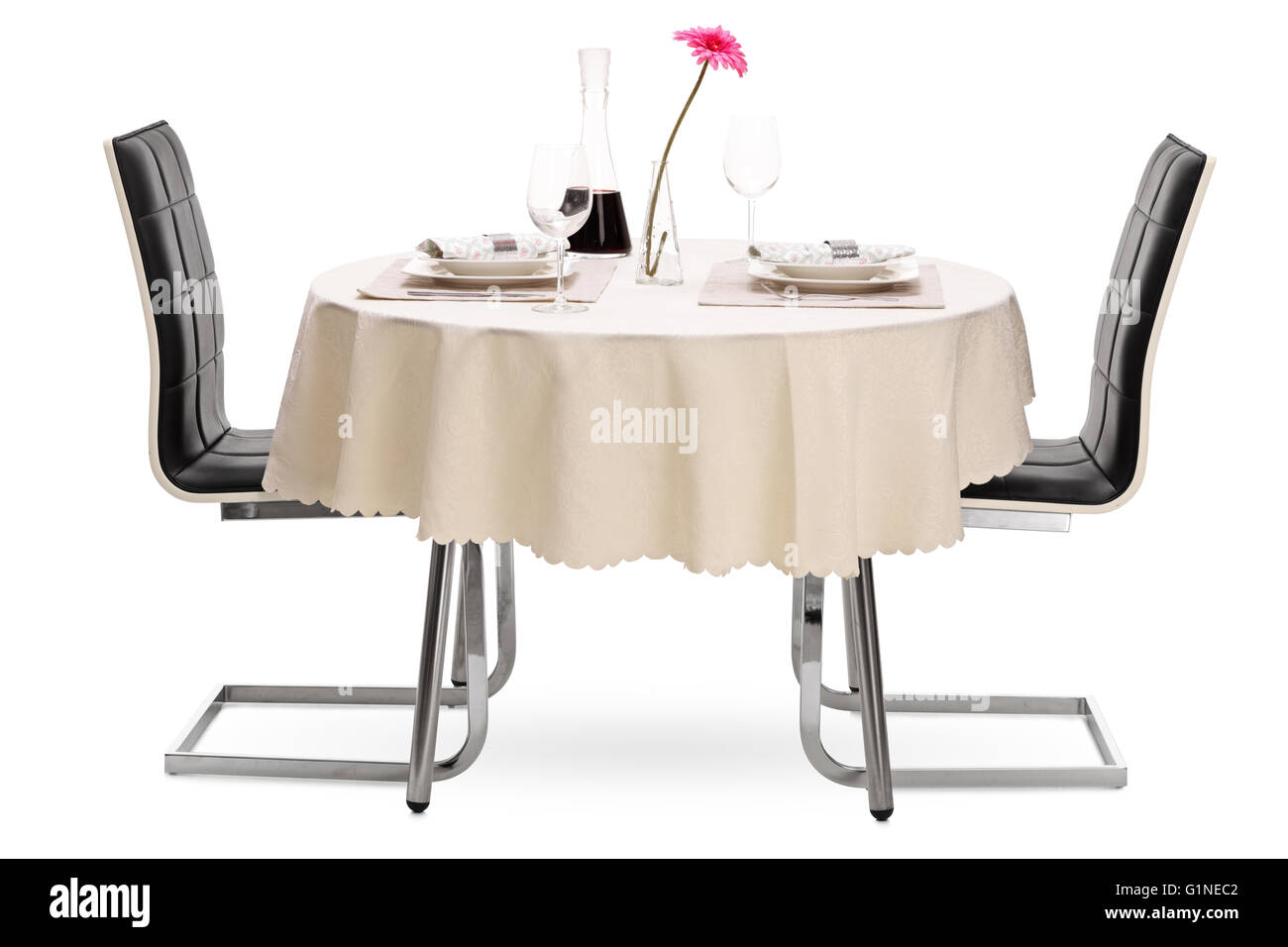Restaurant table with two plates and a bottle of red wine isolated on ...