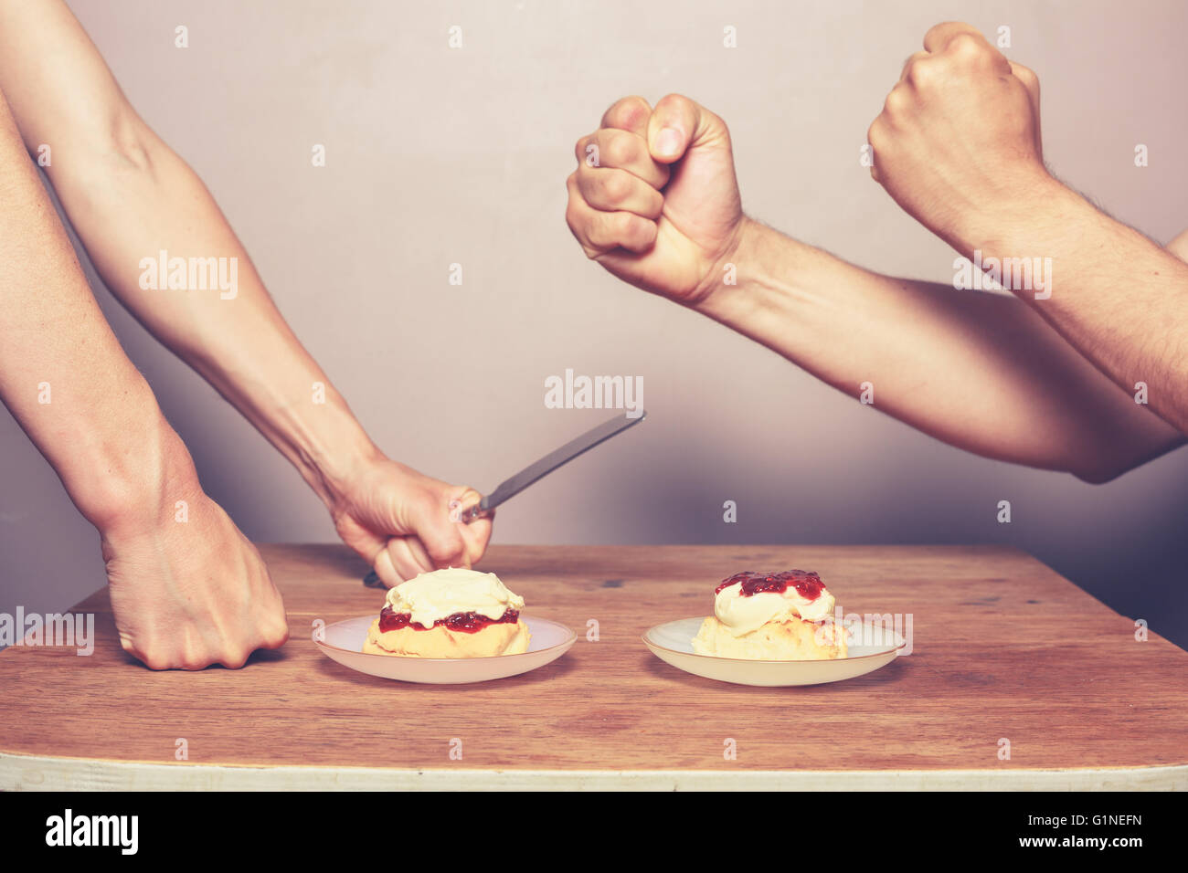 Two people at table are fighting over how to make the perfect cream tea ...