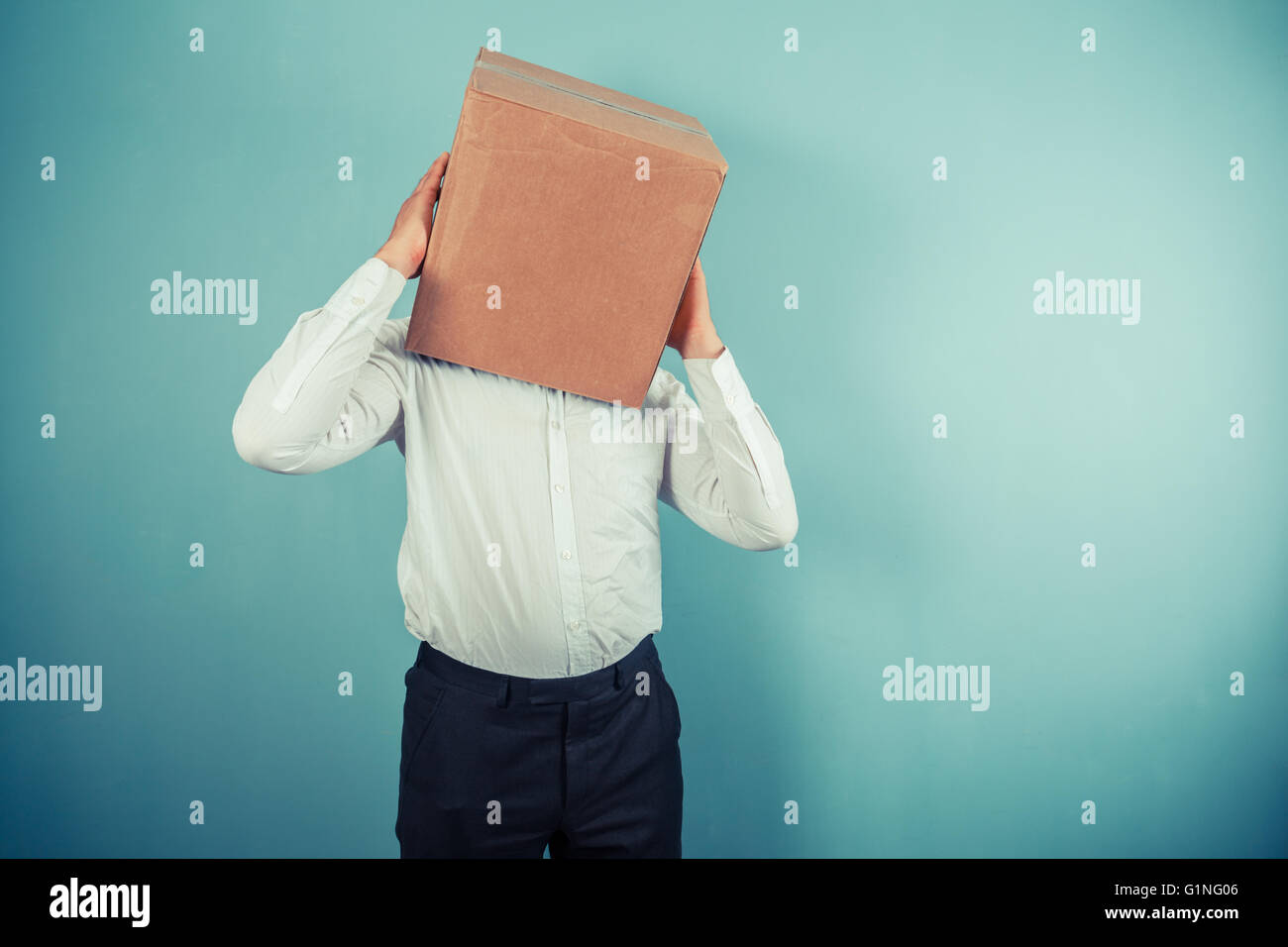 A man is standing around with a cardboard box on his head Stock Photo ...