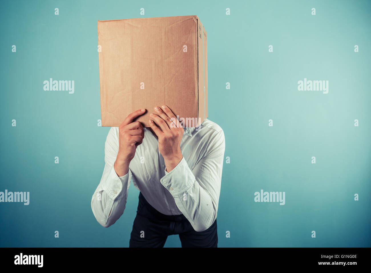 A man is standing around with a cardboard box on his head Stock Photo ...