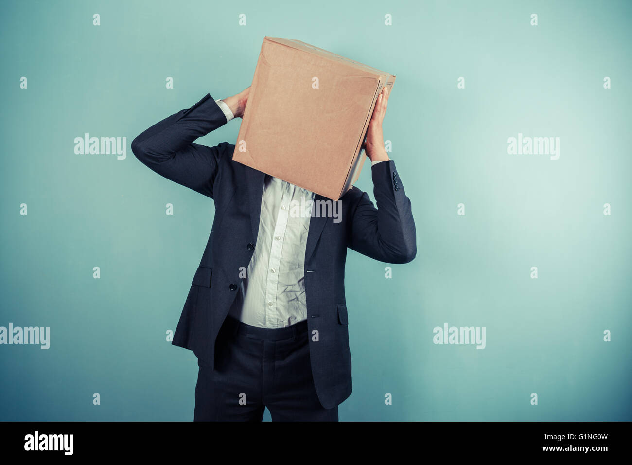 A businessman with a cardboard box on his head has a headache Stock ...