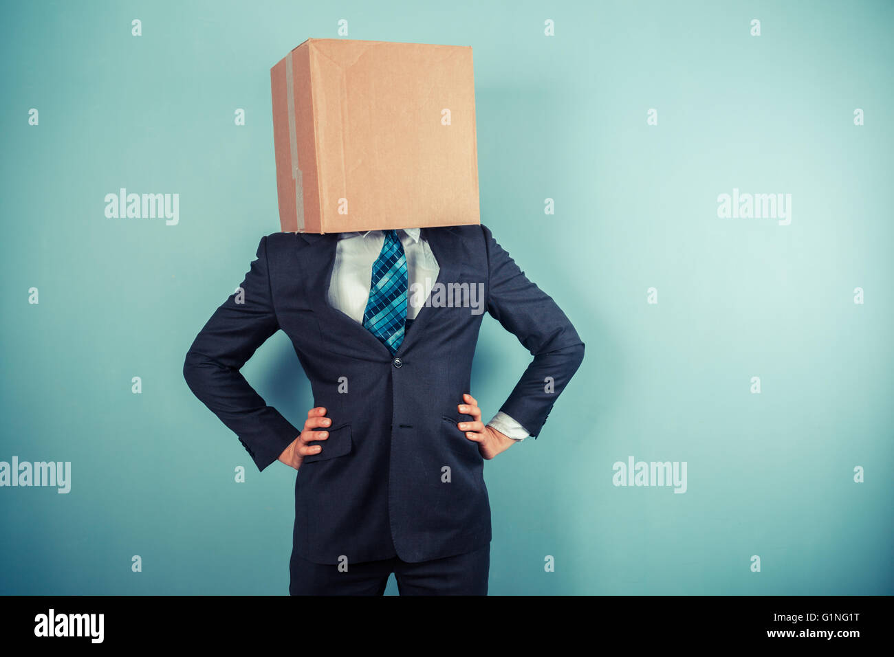 A businessman is standing with a cardboard box on his head Stock Photo ...