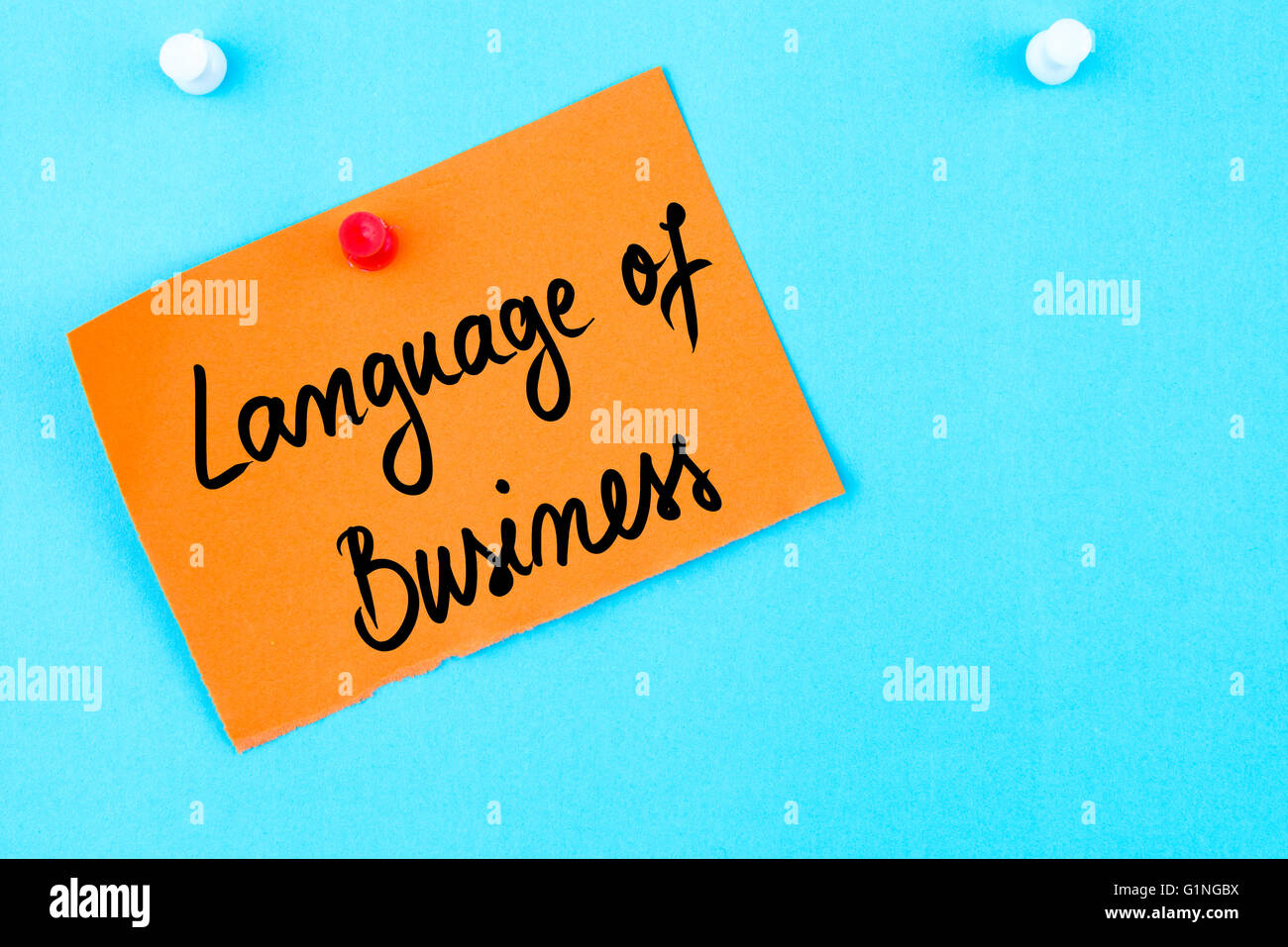 Language Of Business written on orange paper note pinned on cork board ...