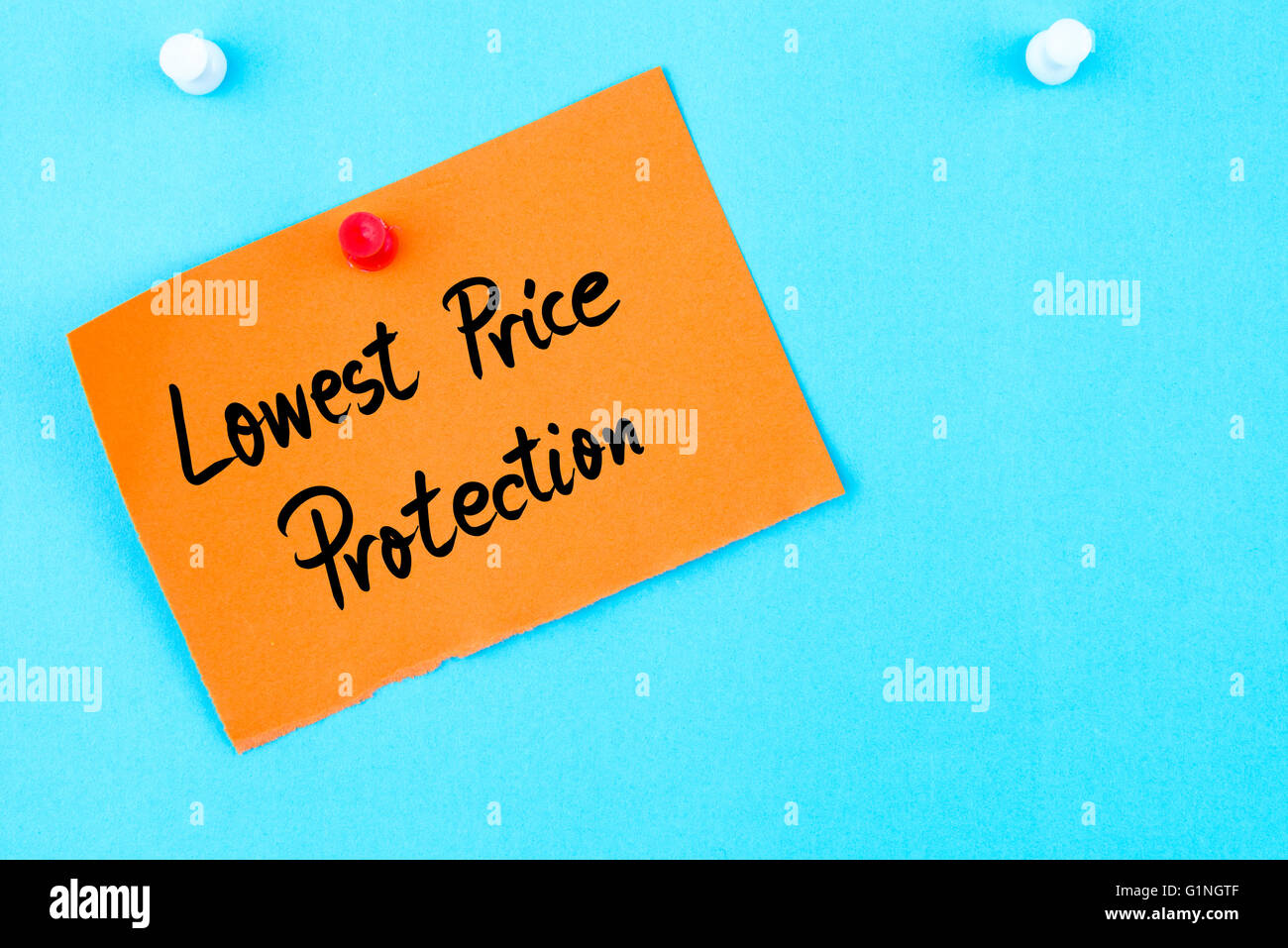 Lowest Price Protection written on orange paper note pinned on cork ...