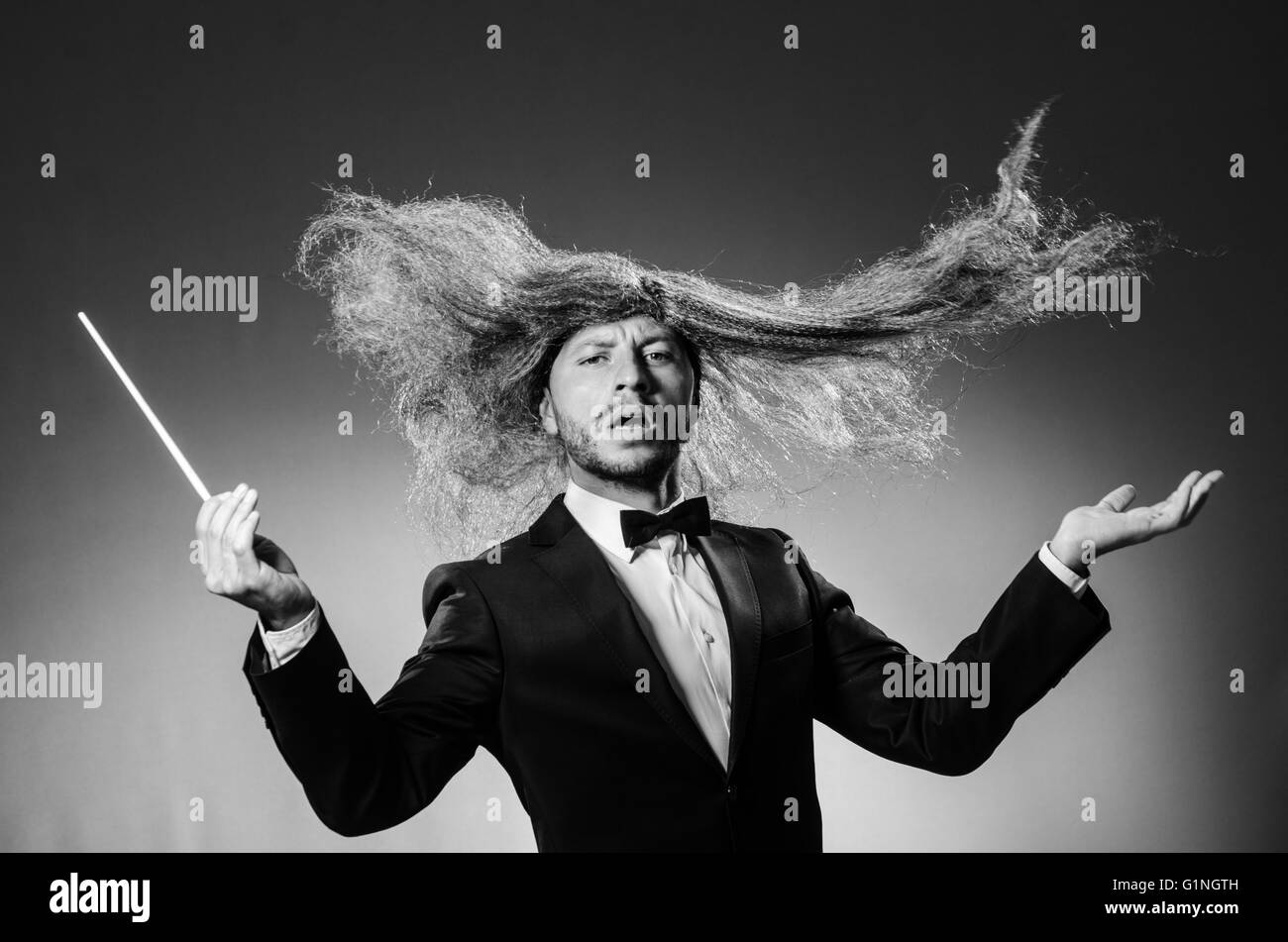 Funny conductor against dark background Stock Photo - Alamy