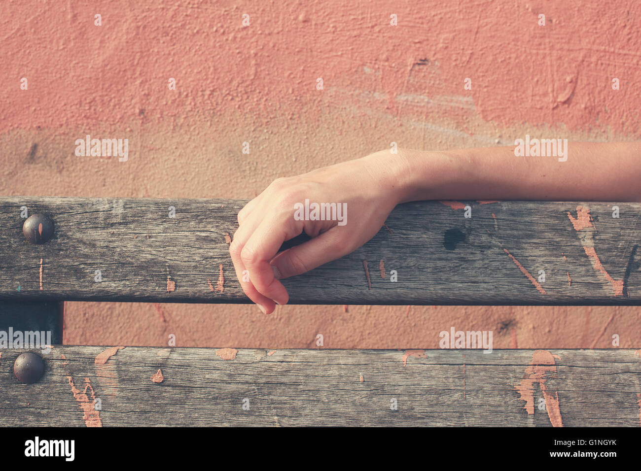 A Young woman's hand is resting on a bench outside in the sun Stock ...