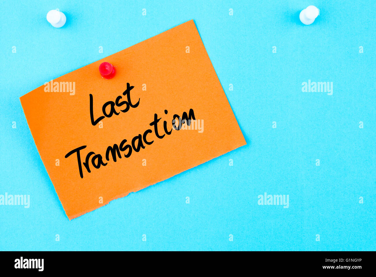 Last Transaction written on orange paper note pinned on cork board with ...