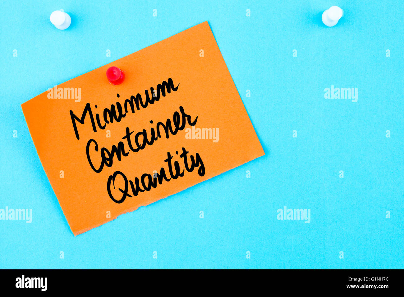 Minimum Container Quantity written on orange paper note pinned on cork ...