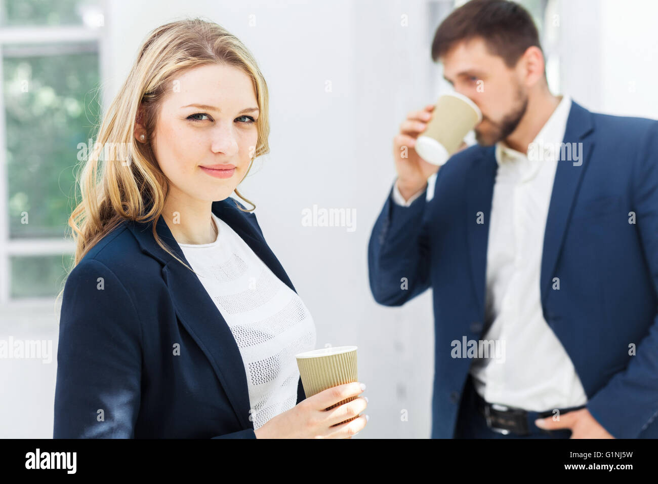 Young colleagues having coffee break in office Stock Photo - Alamy