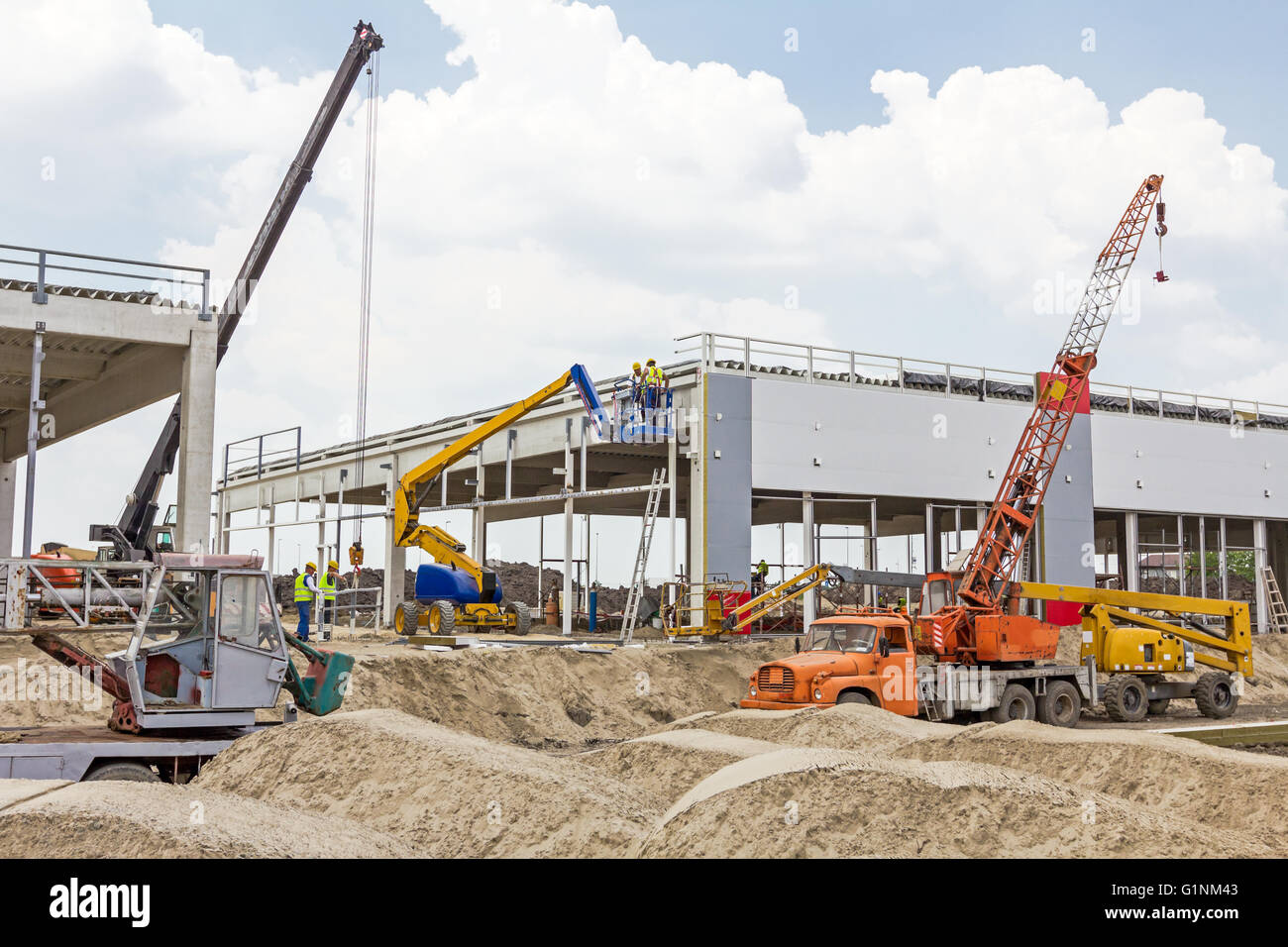 View on construction site with machinery, people at work. Landscape ...