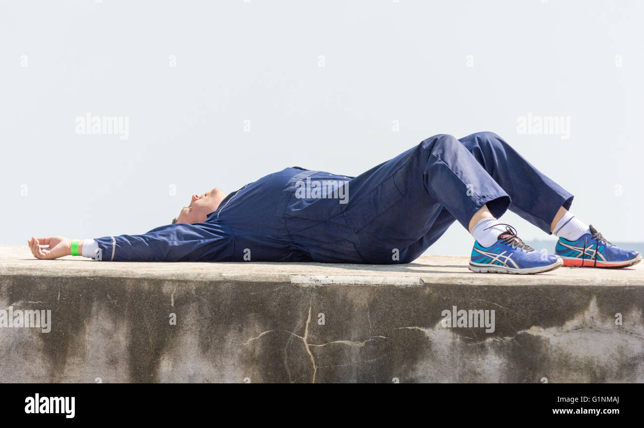 Mechanic resting in the sun after a hard shift Stock Photo - Alamy