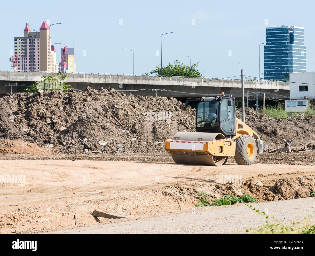 Modern small steamroller for construction the new road in the urban ...