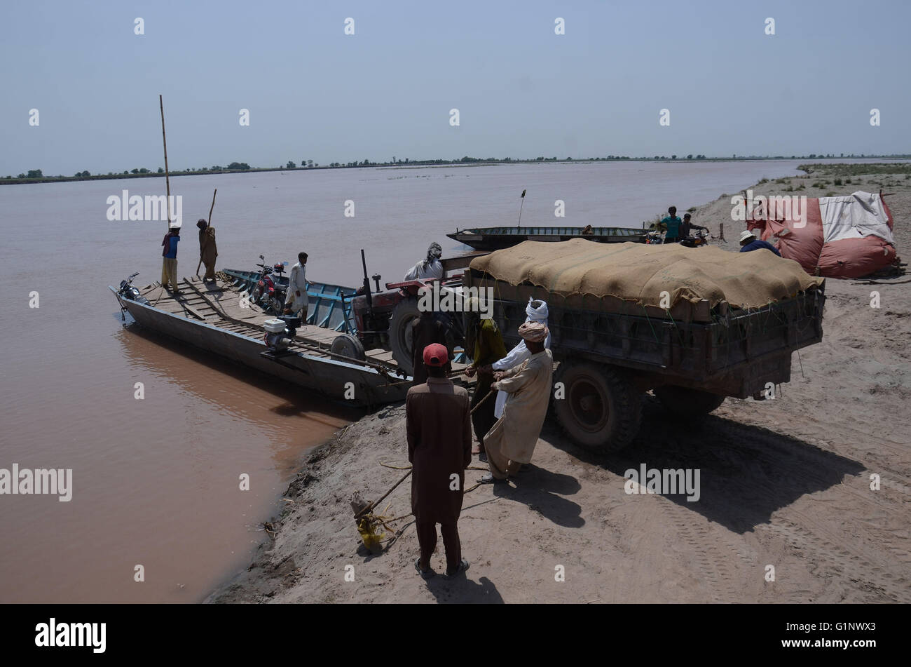 Pakistani farmers loading a tractor trolley loaded with watermelon on a ...