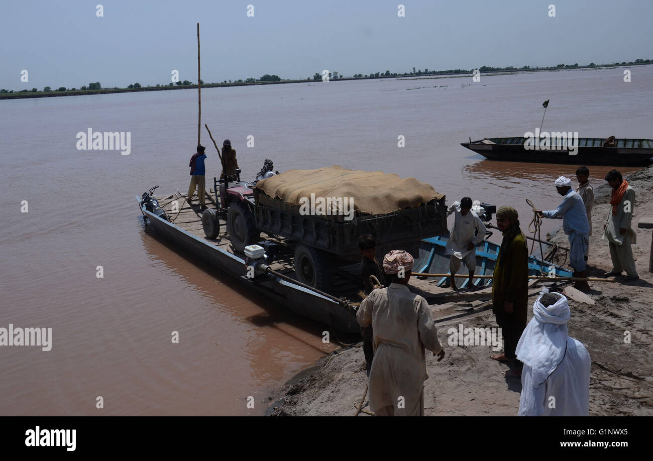 Pakistani farmers loading a tractor trolley loaded with watermelon on a ...