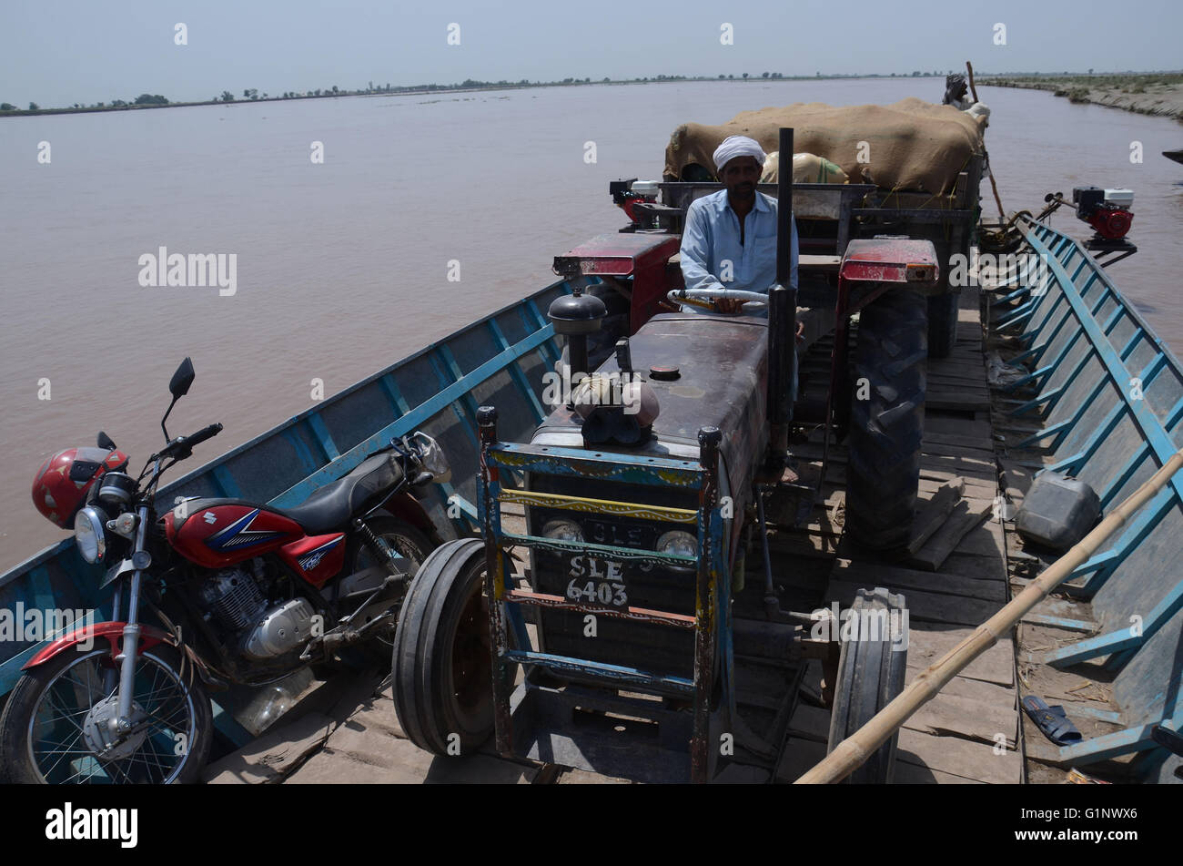 Pakistani farmers loading a tractor trolley loaded with watermelon on a ...