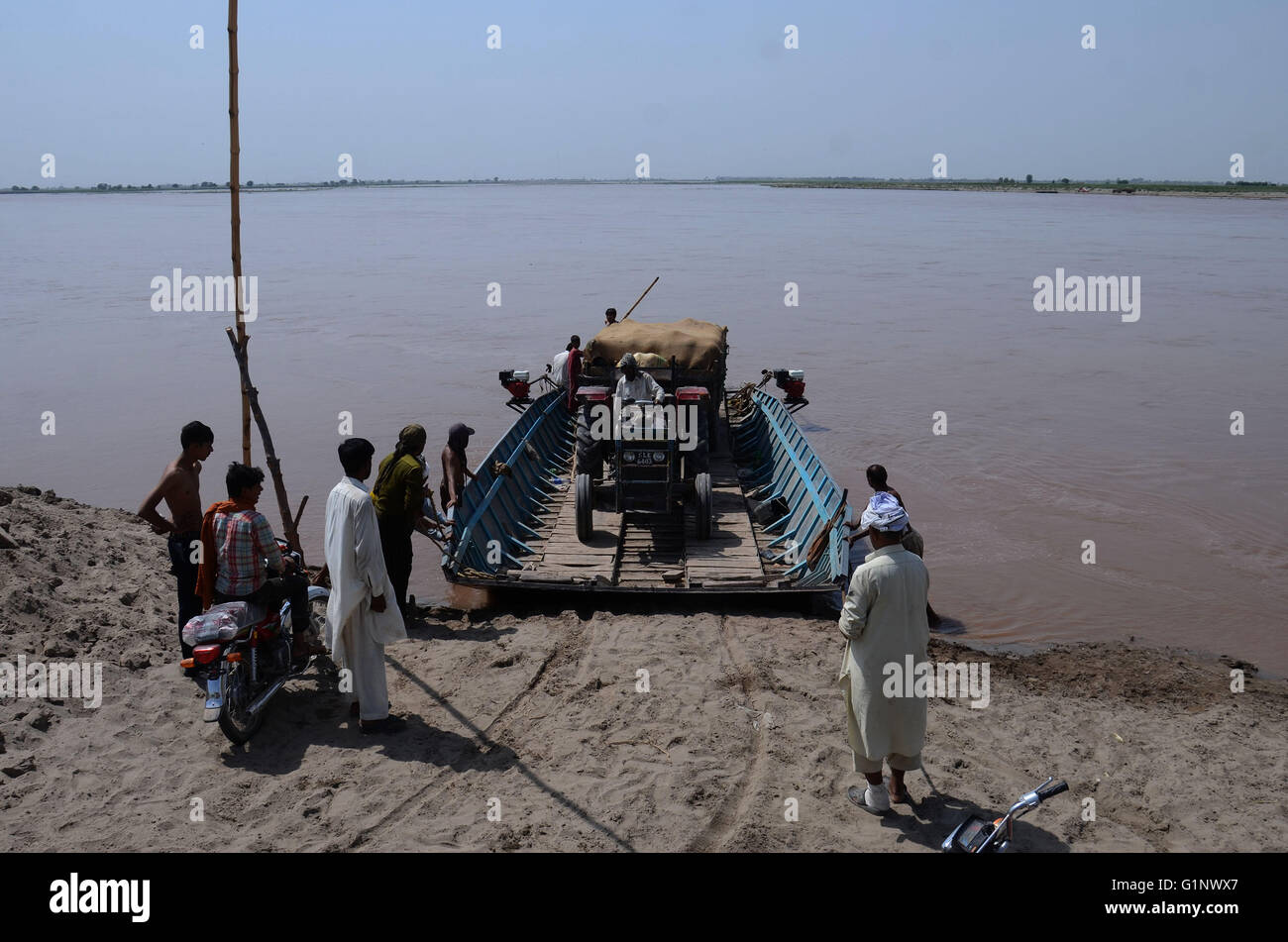 Pakistani farmers loading a tractor trolley loaded with watermelon on a ...