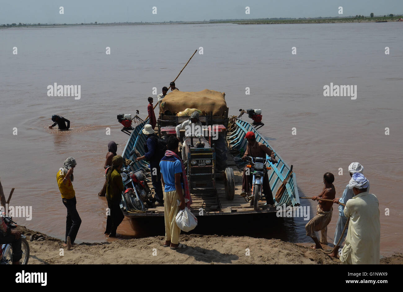 Pakistani farmers loading a tractor trolley loaded with watermelon on a ...