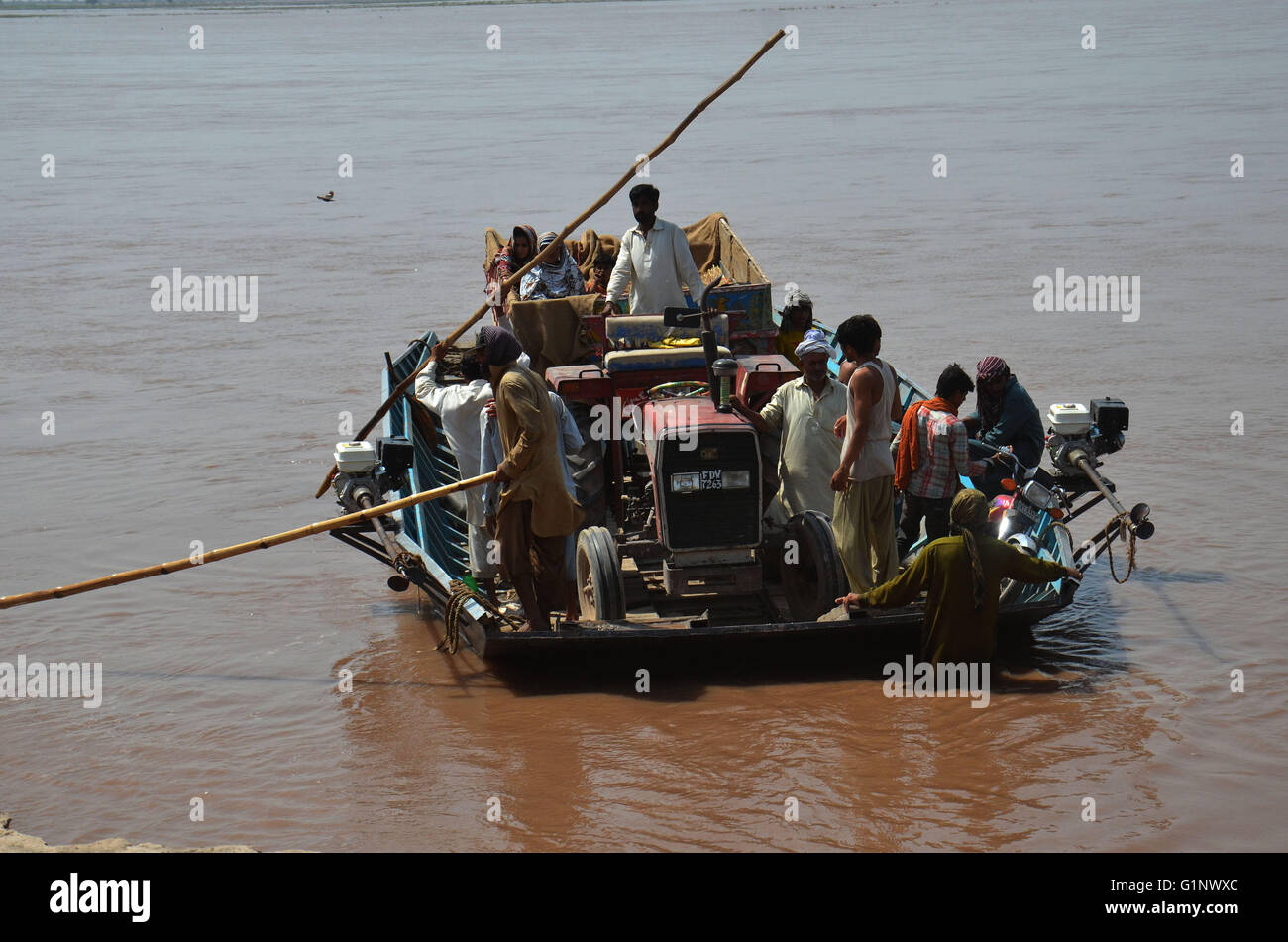 Pakistani farmers loading a tractor trolley loaded with watermelon on a ...