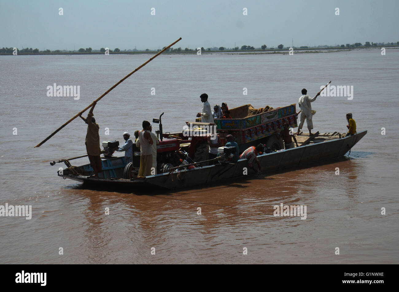 Pakistani farmers loading a tractor trolley loaded with watermelon on a ...