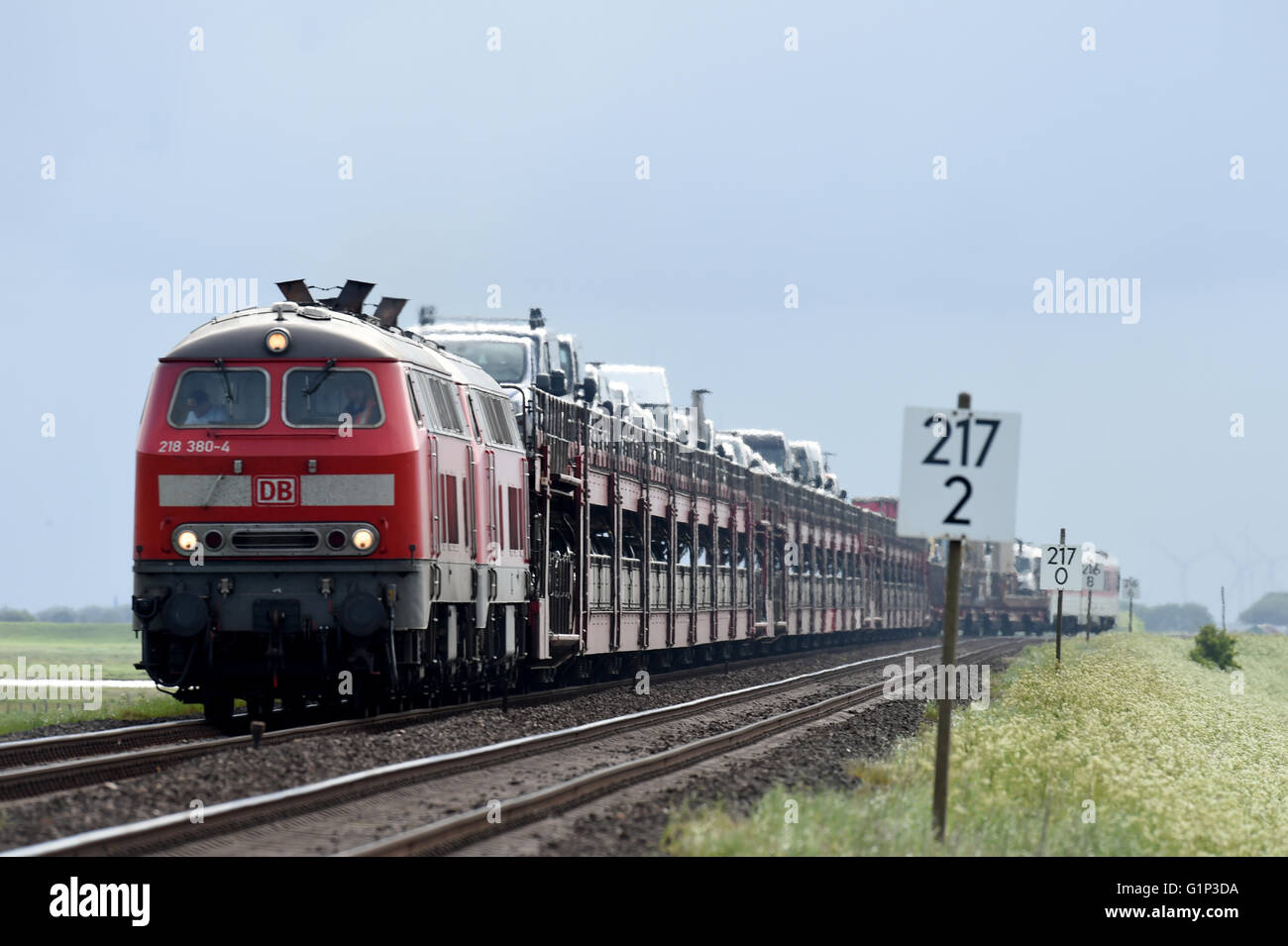 A Deustche Bahn train with cars aboard travelling on near Klanxbuell ...