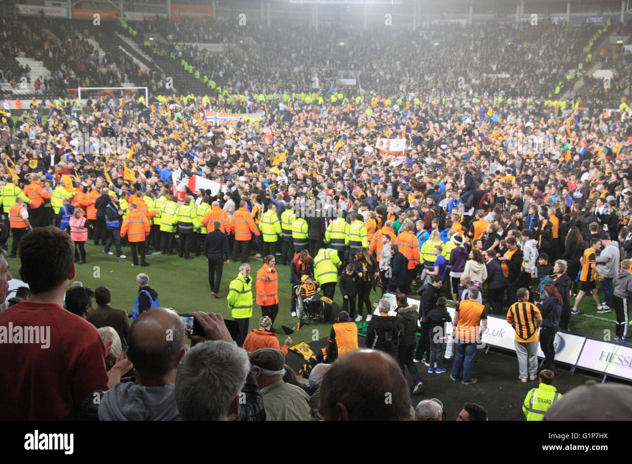 Hull City football fans celebrate on the pitch at the KCom Stadium on reaching Wembley for the ...
