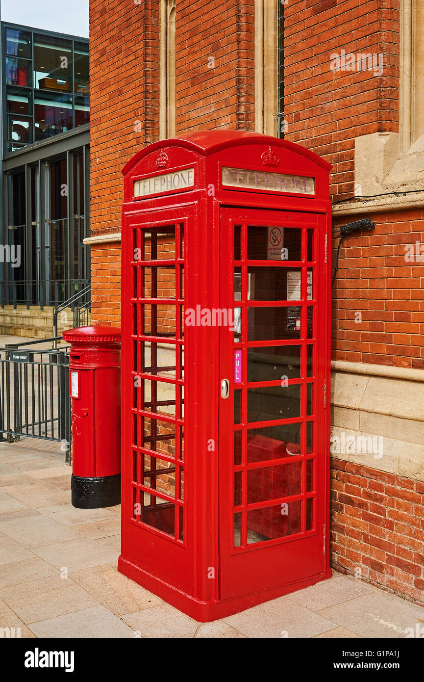 Red phone box and red telephone box outside of building Stock Photo - Alamy
