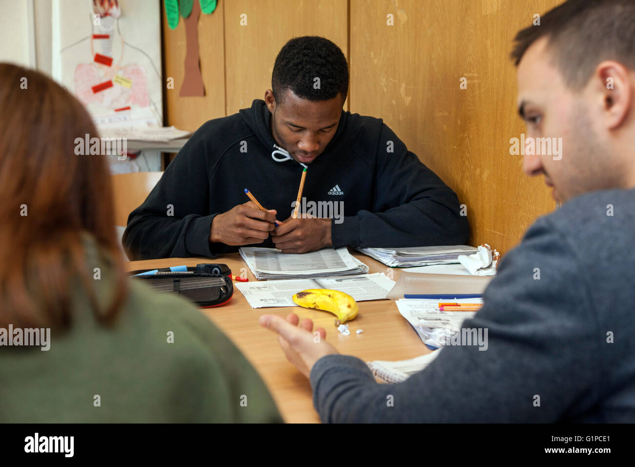 Students in the classroom during a writing task Stock Photo - Alamy