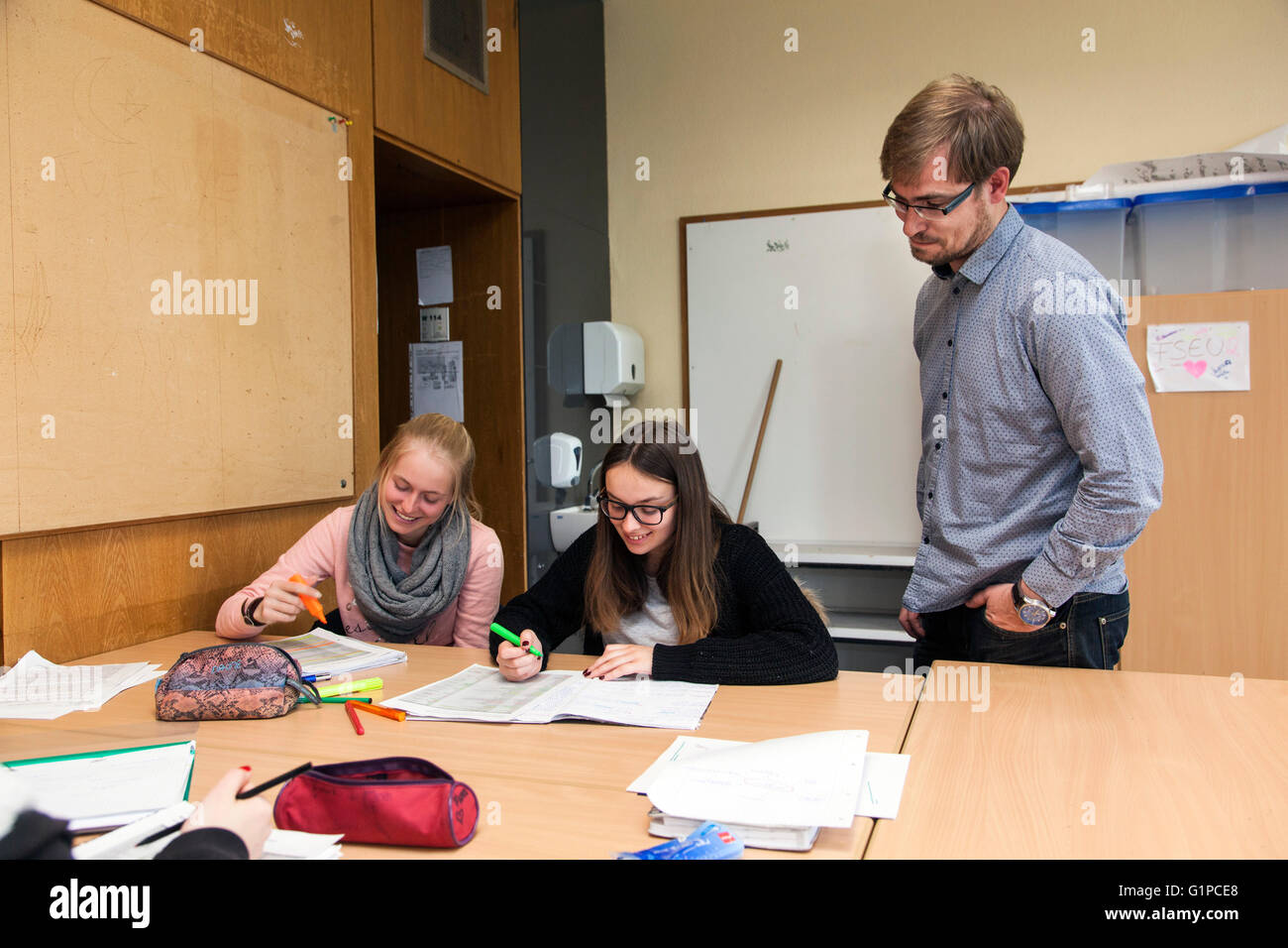 Students in the classroom during a writing task Stock Photo - Alamy
