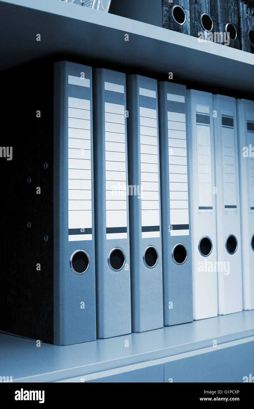 Folders for documents on a book shelf at office Stock Photo - Alamy