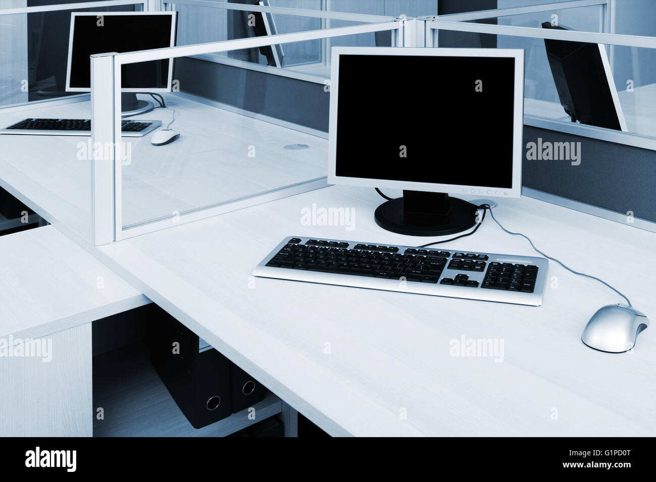 computers behind the glass in a modern office Stock Photo - Alamy