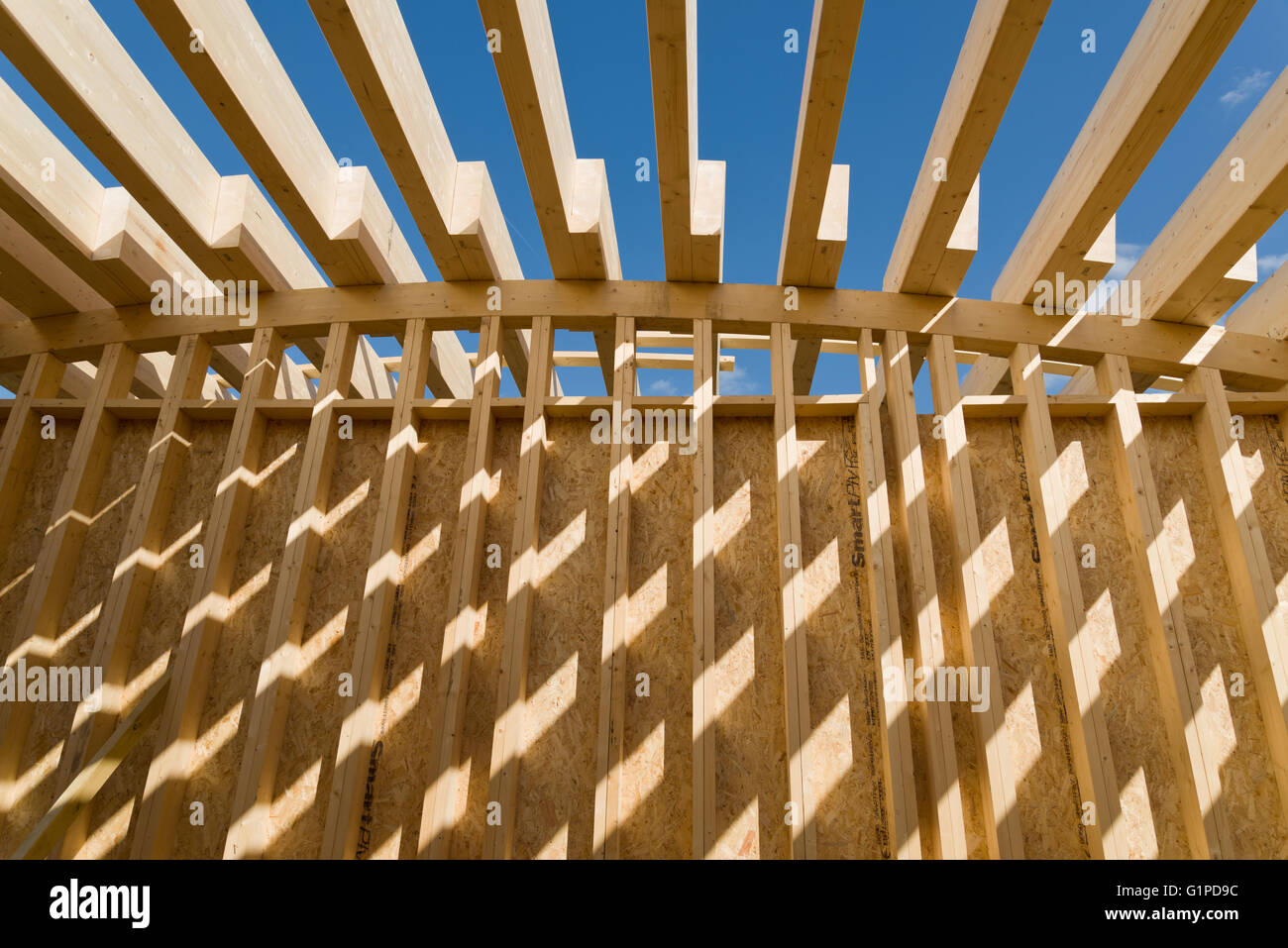 Timber frame building being erected. Wooden structure partially ...
