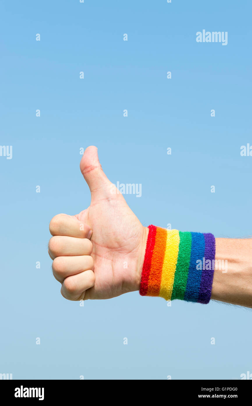 Hand of athlete giving thumbs up with gay pride rainbow colors ...