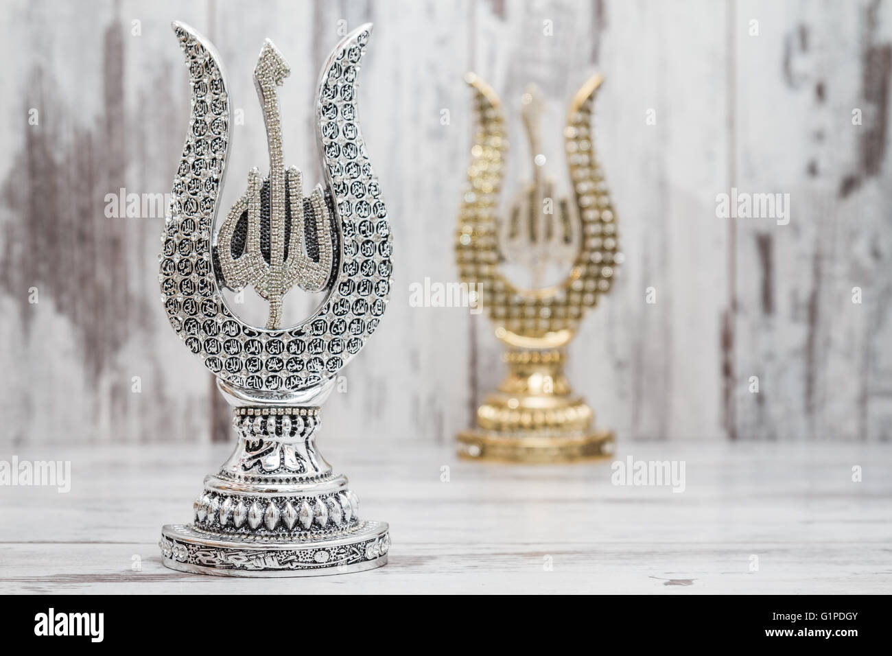 Silver and Golden Religious statuettes with the names of Allah, the God ...