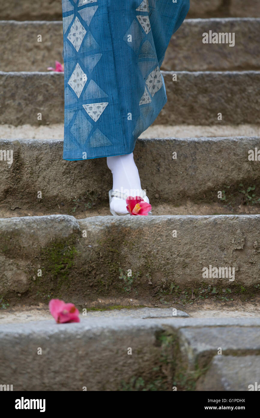 Woman's feet in kimono with Zouri (Japanese sandals) on stone stairs ...