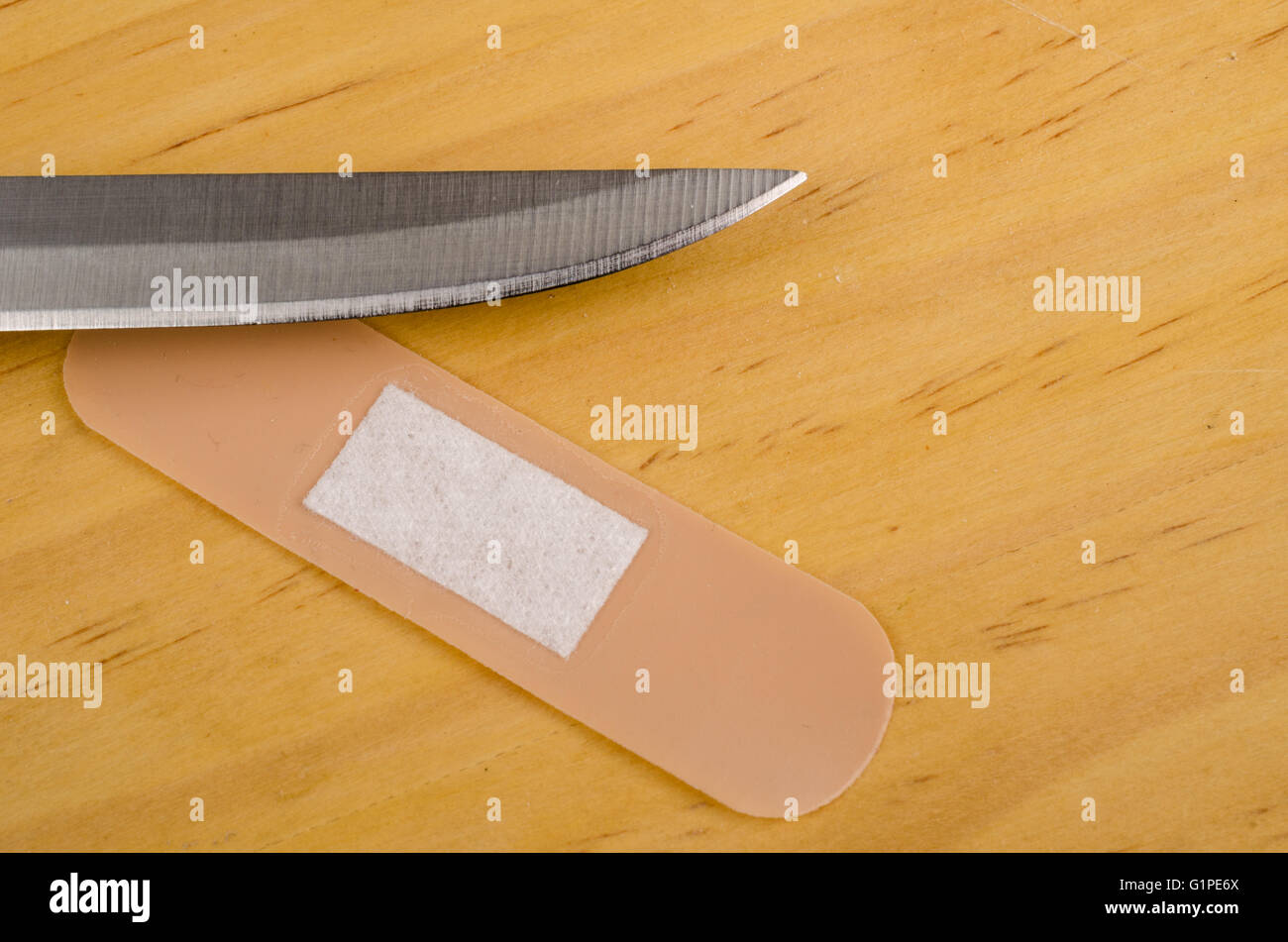 Kitchen knife and band aid, domestic accident concept Stock Photo - Alamy
