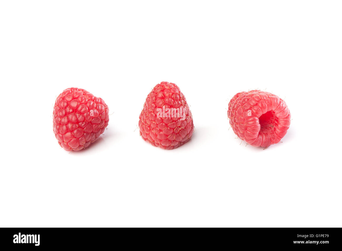 Three red raspberries, isolated on white background Stock Photo - Alamy