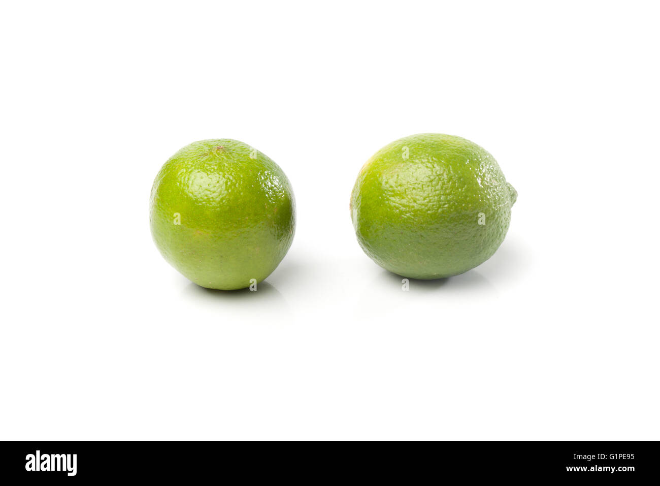 Two green limes, fruit, isolated on white background Stock Photo - Alamy