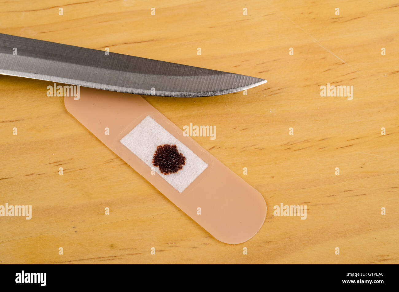 Kitchen knife and band aid, domestic accident concept Stock Photo - Alamy
