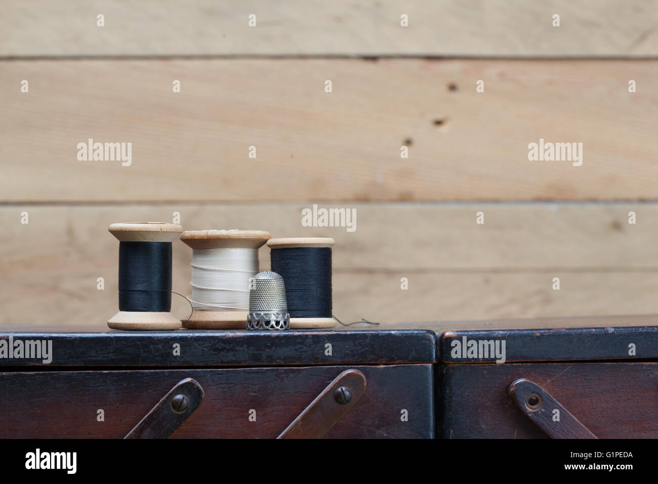 Threads, thimble on top of a vintage storage box for hobby embroidery ...