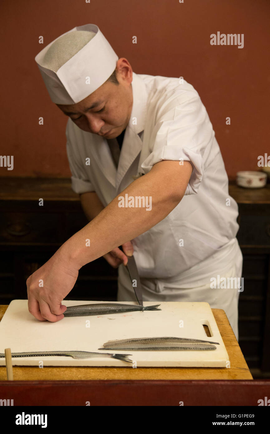 Japanese cook preparing fish Stock Photo - Alamy