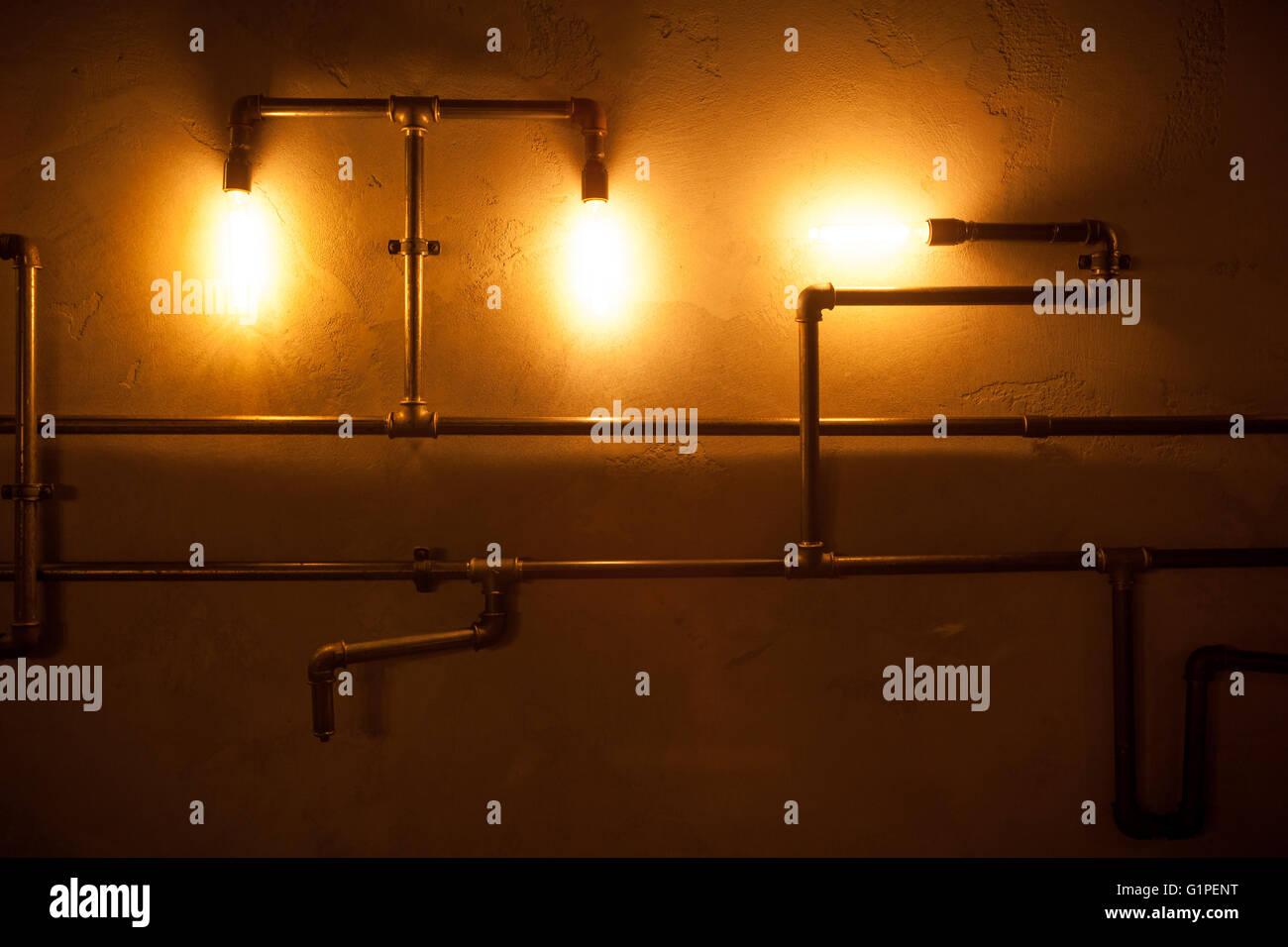 Decorative tubes and lamps on the wall Stock Photo - Alamy