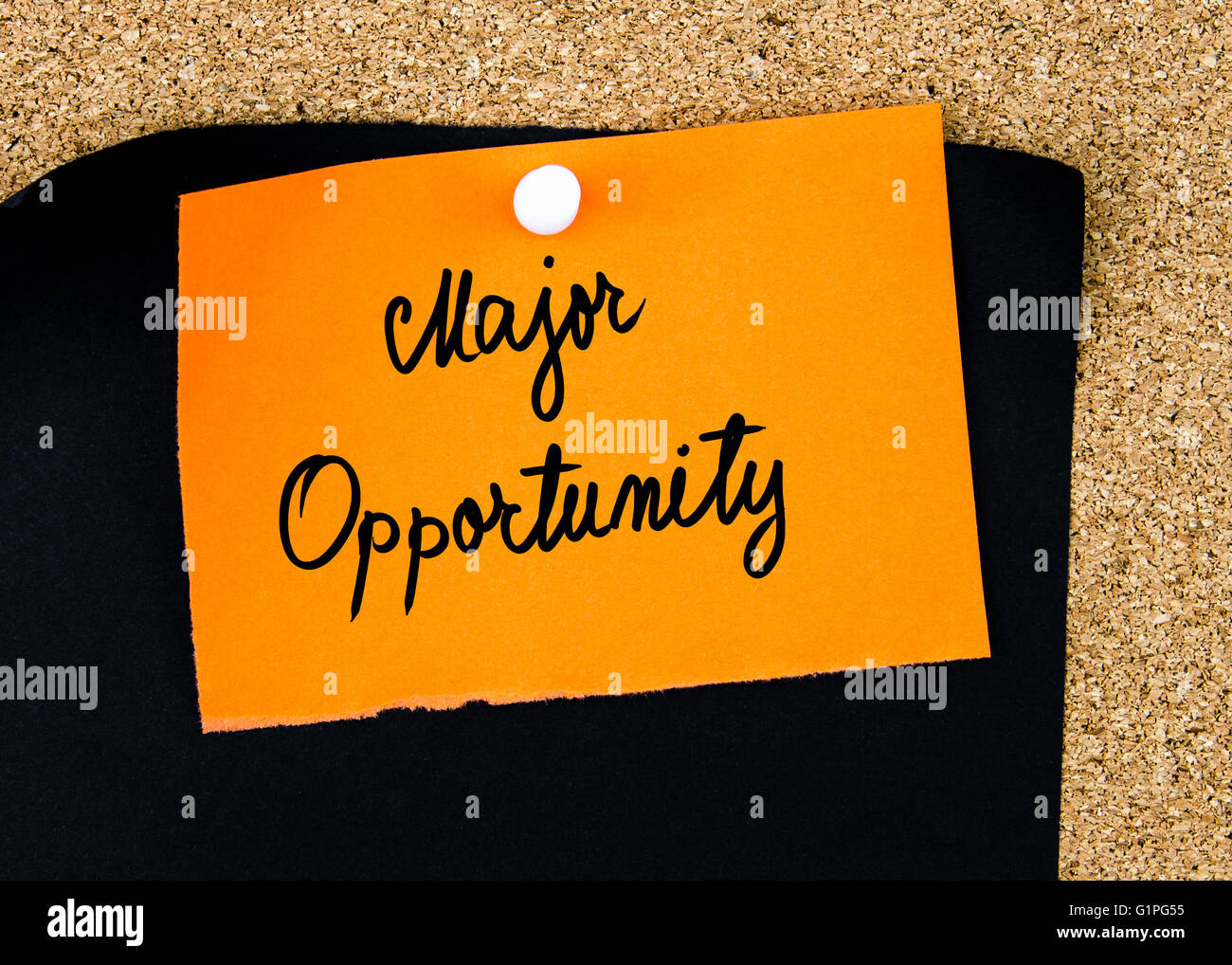 Major Opportunity written on orange paper note pinned on cork board ...