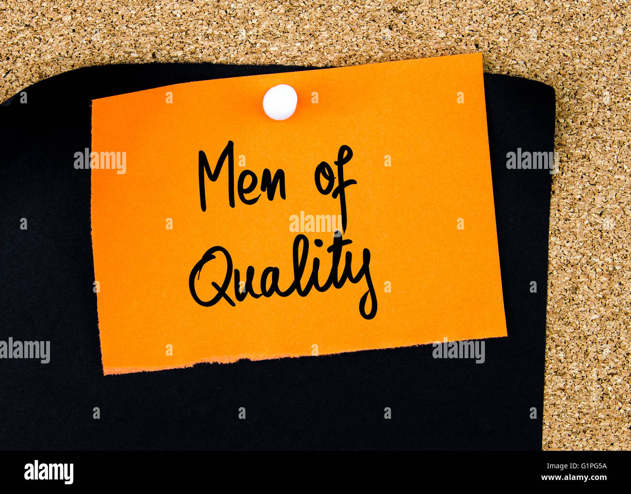 Men Of Quality written on orange paper note pinned on cork board with ...